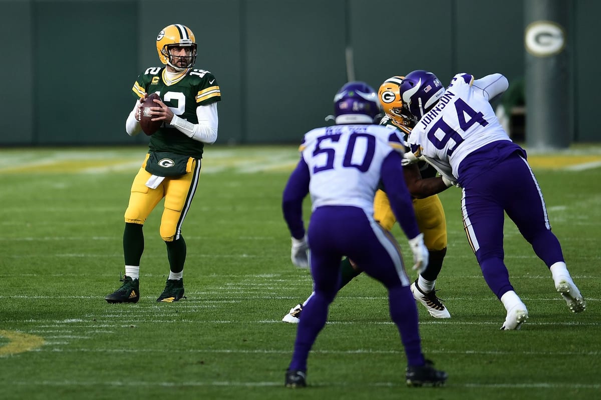 How has QB Aaron Rodgers fared against the Vikings?