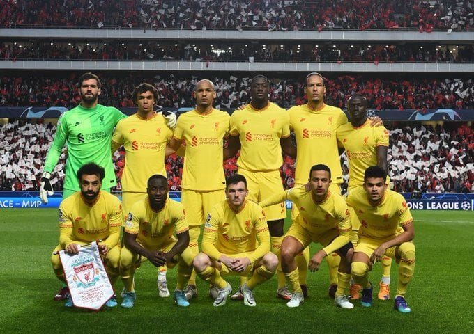 Liverpool's Andy Robertson reacts after being hit with lighters by ...
