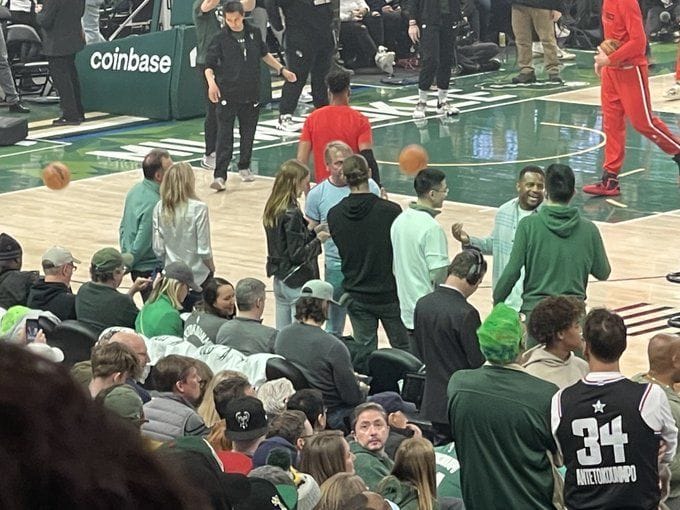 Aaron Rodgers sitting with daughter of Bucks team owner at playoff game