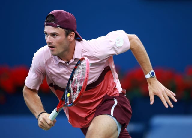 Tommy Paul helps ball girl retrieve a stuck ball during China Open 1R ...