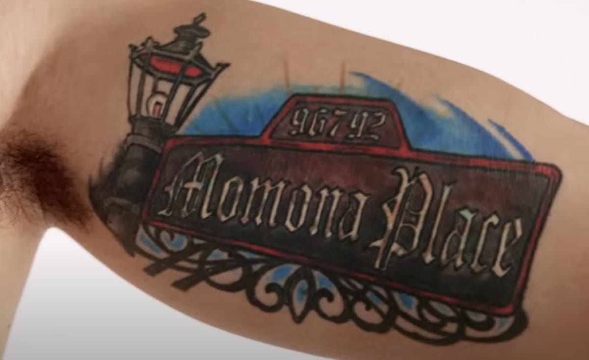 What does Max Holloway's tattoo say?