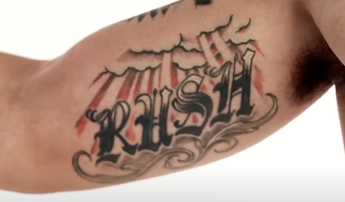 What does Max Holloway's tattoo say?