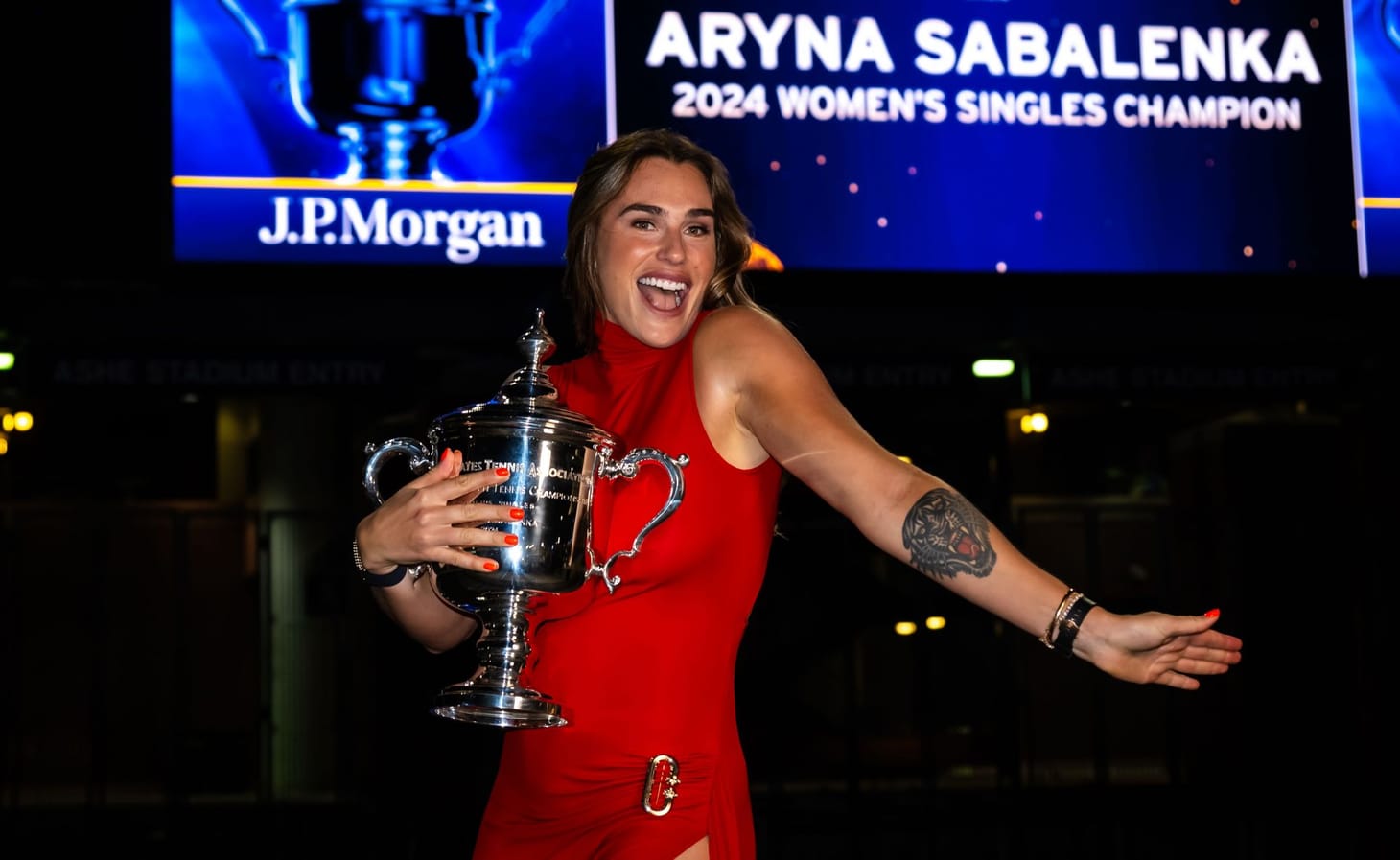 In Pictures: Aryna Sabalenka dazzles in spectacular red gown as she poses with her trophy during ...