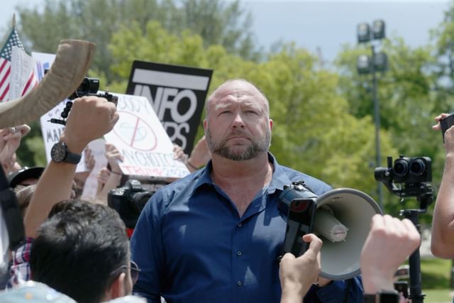 "This is too historic" — Alex Jones struggles to open a bottle of ...