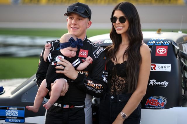 John Hunter Nemechek’s wife Taylor dons a chic all-black backless outfit stitched with white bows