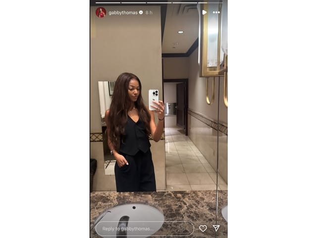 Gabby Thomas suits up with a selfie during holiday season