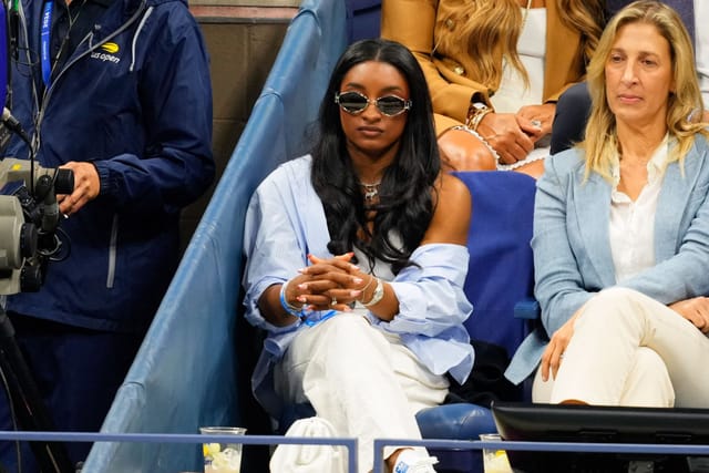 Simone Biles rocks a light pink tracksuit as she shares travel day ...