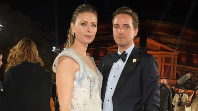 Maria Sharapova adorably holds fiance Alexander's arm as couple turn heads in stylish outfits at ...