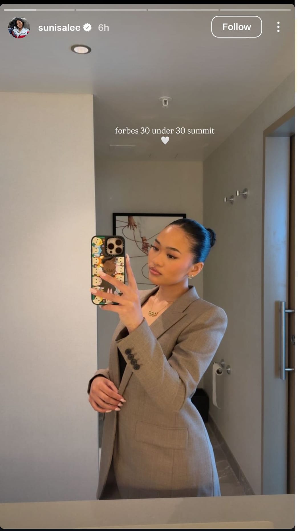 Suni Lee poses in brown blazer and slicked back hair as she turns heads ...